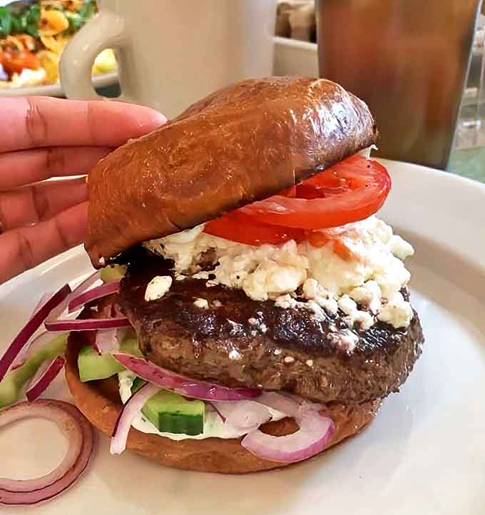 This isn't just any burger &ndash; it's a Greek-inspired masterpiece with feta, fresh vegetables, and a perfectly seasoned patty on a golden brioche bun.