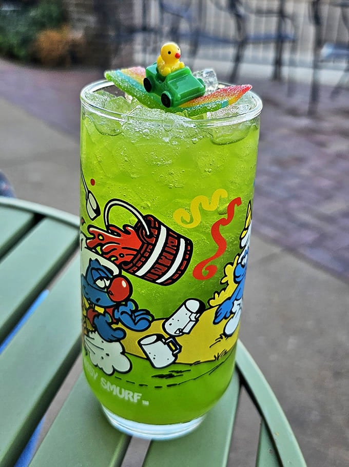 The Green Apple Fizz arrives with a rubber duck in a toy car because sometimes drinks need whimsy as much as alcohol.