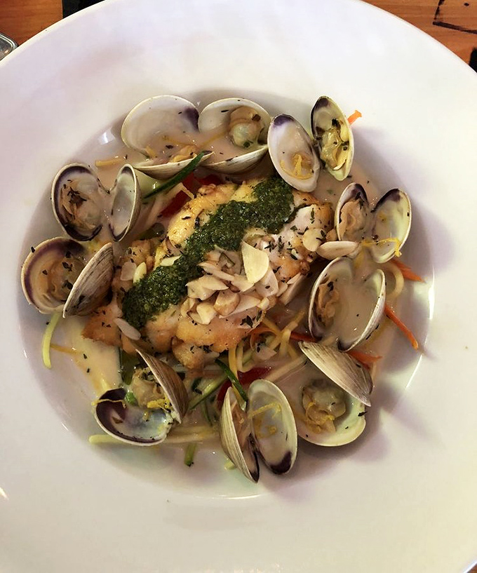 A seafood symphony where delicate fish meets littleneck clams, all harmonized with bright pesto and fresh herbs.