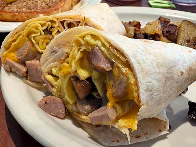 A breakfast burrito stuffed with all the good stuff, wrapped up tight and ready to fuel your day like a delicious handheld power source.