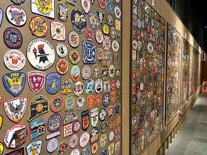 Thousands of fire department patches create a colorful mosaic representing the global brotherhood of firefighters who protect communities everywhere.