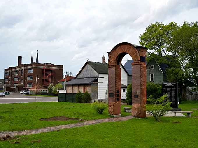 The Italian Hall memorial arch stands as a solemn reminder of the 1913 tragedy where 73 souls, mostly children, were lost.