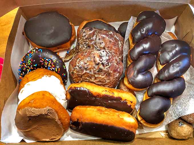 A baker's dozen of glazed, frosted, and chocolate-covered happiness circles, proving donuts are the most democratic of all breakfast foods.