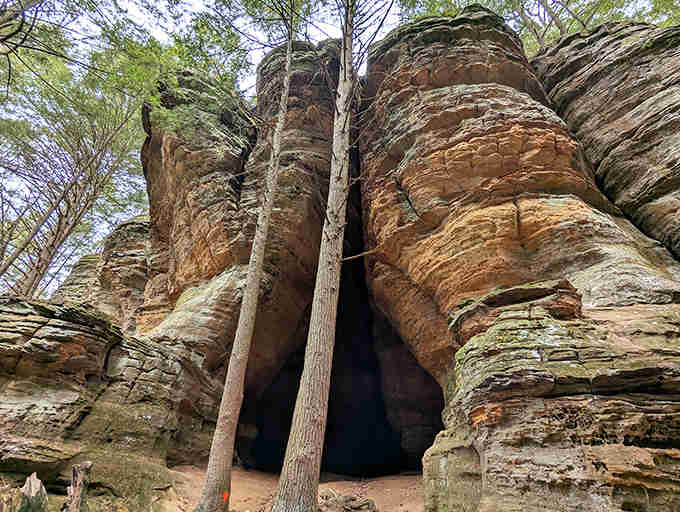 Massive rock formations dwarf visitors, offering a humbling reminder of our small place in Earth's grand geological timeline.