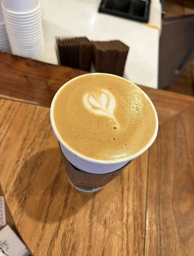 Latte art that's almost too pretty to drink &ndash; almost. The delicate leaf pattern floats atop a canvas of espresso perfection.