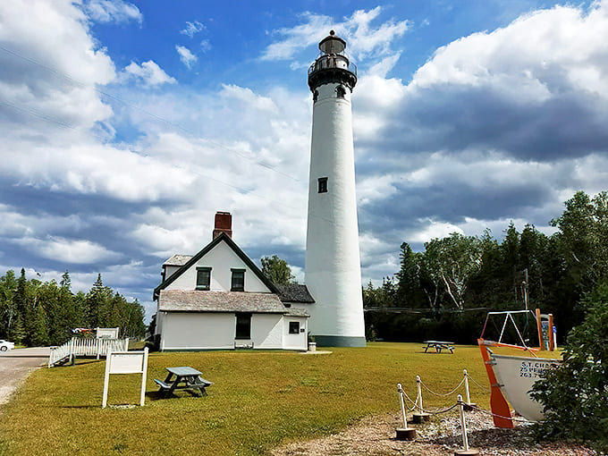 The lighthouse stands sentinel over Lake Huron, a postcard-perfect reminder of Michigan's rich maritime history.