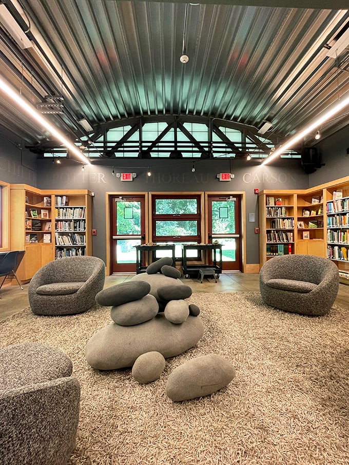 The modern visitor center offers comfortable seating among literary treasures, perfect for plant enthusiasts needing a rest.