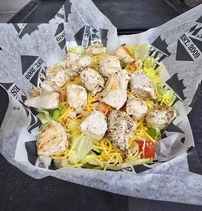 Grilled chicken transforms a simple salad into something special, because even greens deserve the royal treatment here.