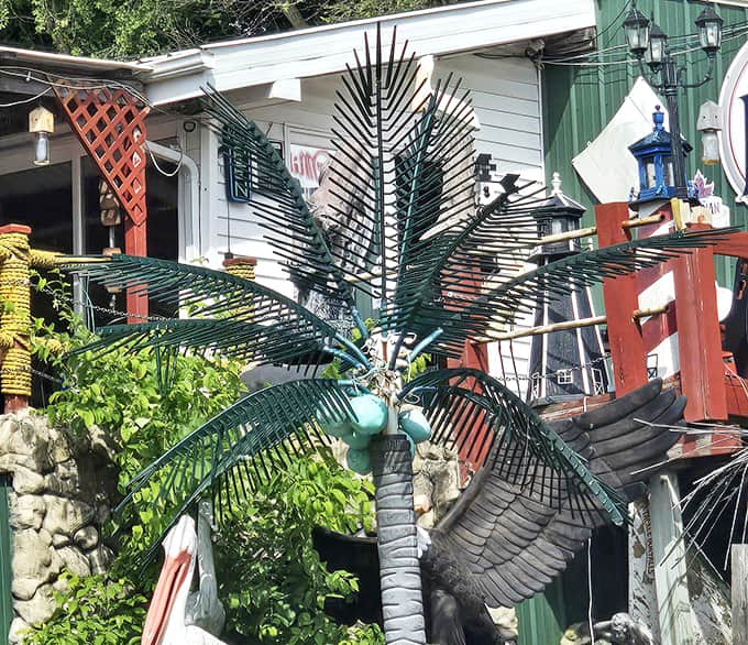 Where tropical dreams meet Midwest reality &ndash; this metal palm tree stands as a quirky sentinel outside the restaurant.