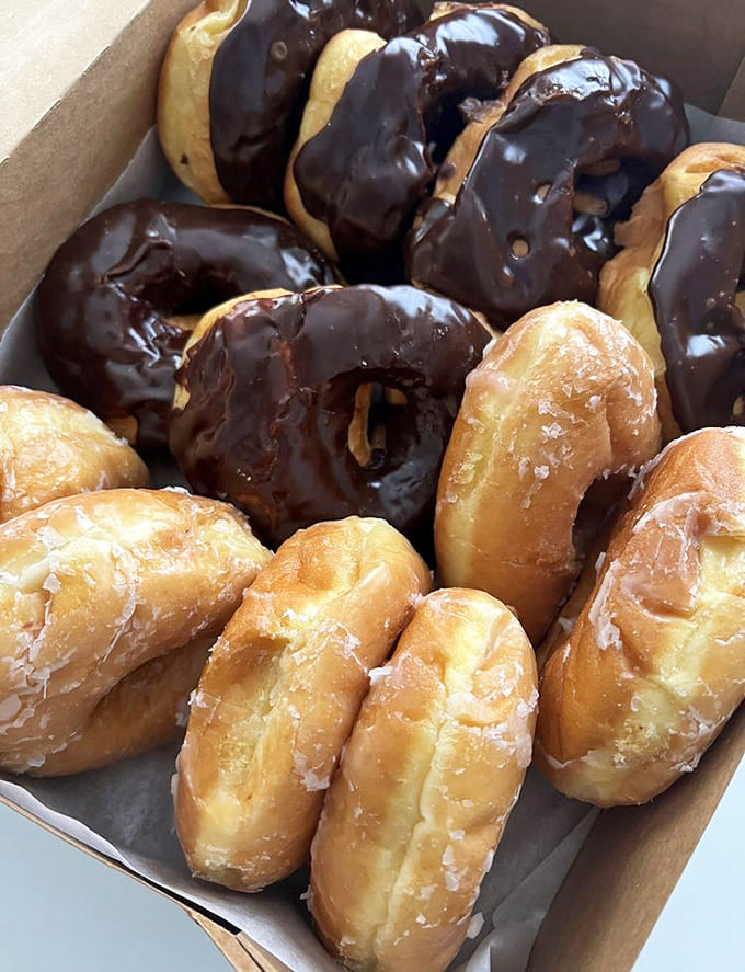 Plain glazed and chocolate glazed sitting together like the dynamic duo of the donut world, simple perfection times two.