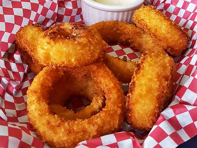Golden, crispy, and substantial, these onion rings aren't mere sides &ndash; they're supporting actors worthy of their own spotlight moment.