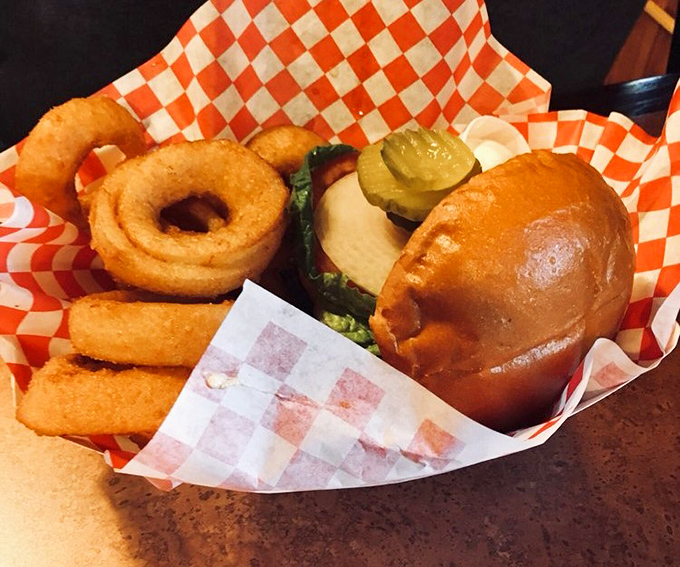 Beer-battered onion rings thick enough to see and a burger that means business, this is the kind of meal that requires loosening your belt and zero regrets.