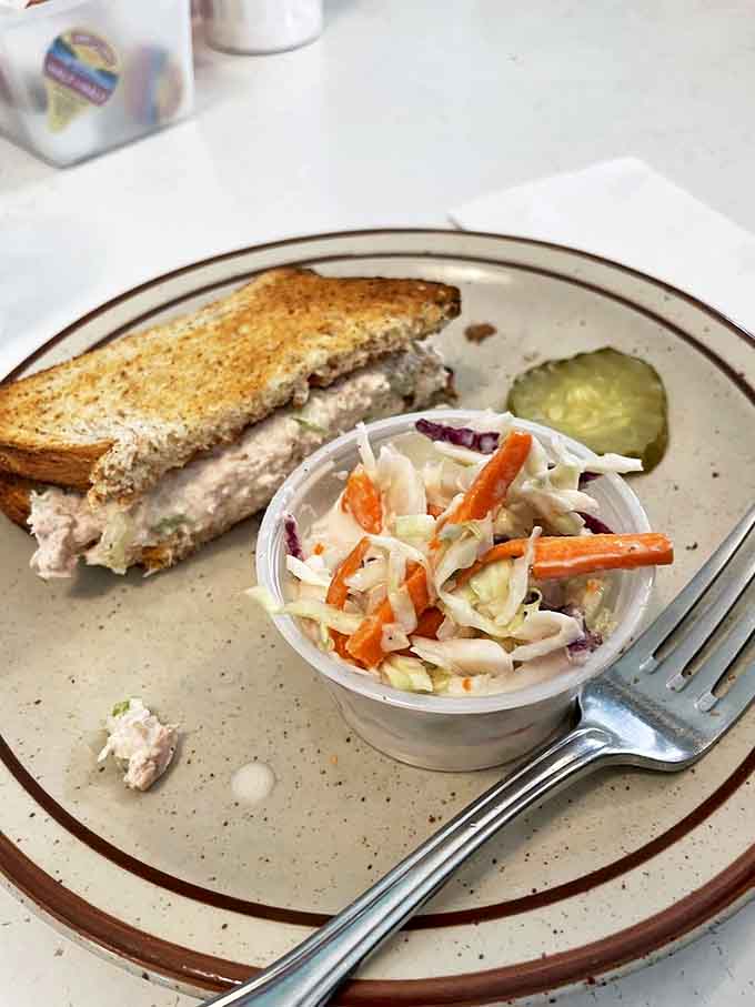 A tuna sandwich that proves lunch isn't an afterthought here, accompanied by coleslaw that adds the perfect crunch.