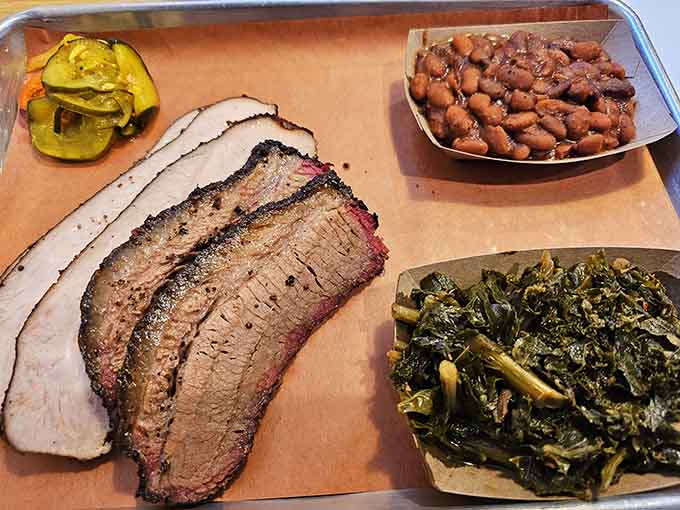 Brisket with that perfect smoke ring, tender slices, and sides that complete the holy trinity of barbecue perfection.
