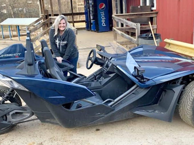 Part car, part motorcycle, all adrenaline &ndash; this sleek Polaris Slingshot waits for its next pilot to take it on a mud-splattered joyride.