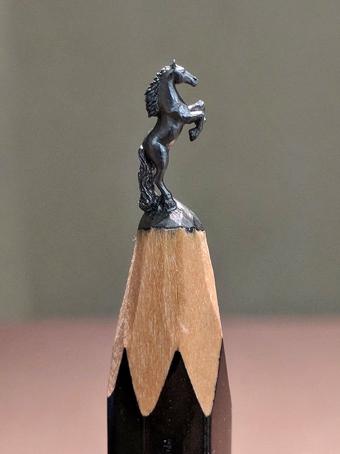 A horse sculpture so small it could race across a penny, this micro-masterpiece demonstrates the almost supernatural patience required to create art at this scale.