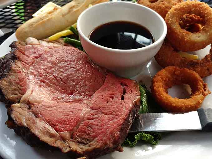Prime rib sliced thick and cooked just right, accompanied by onion rings that could make a vegetarian reconsider their life choices.
