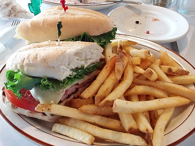 The classic club sandwich &ndash; architectural perfection between bread slices with fries that achieve the golden ideal of crispy outside, fluffy inside.