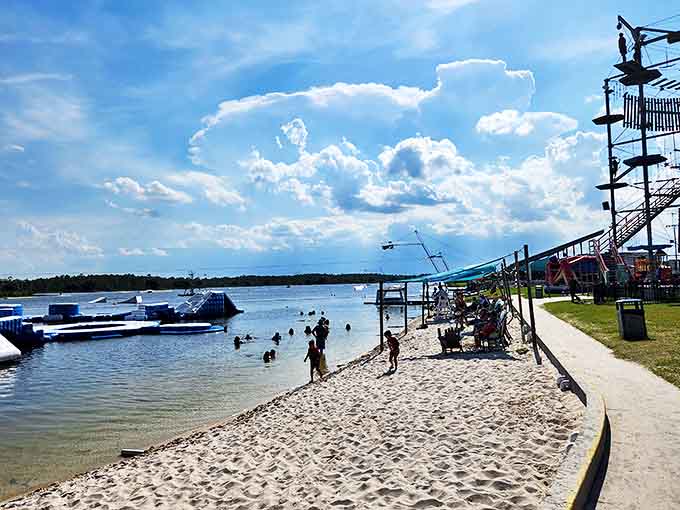 The sandy shoreline offers a perfect vantage point for watching family members attempt (and hilariously fail at) mastering the floating obstacles.