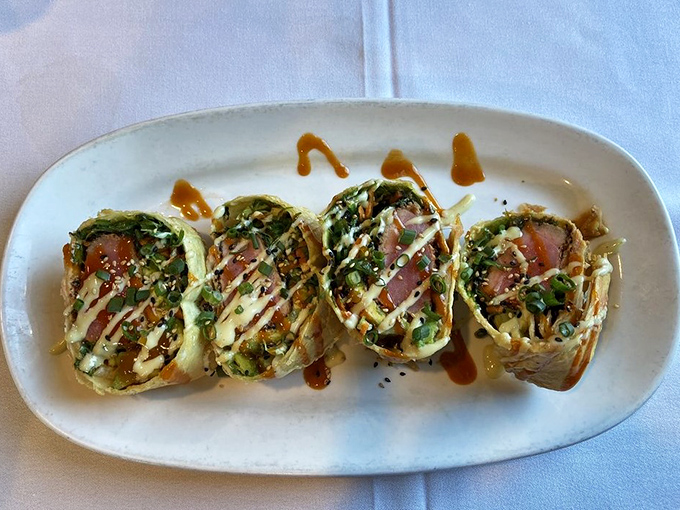 The seared tuna wrap bundles rare, velvety fish with crisp vegetables in a handheld package of pure delight.