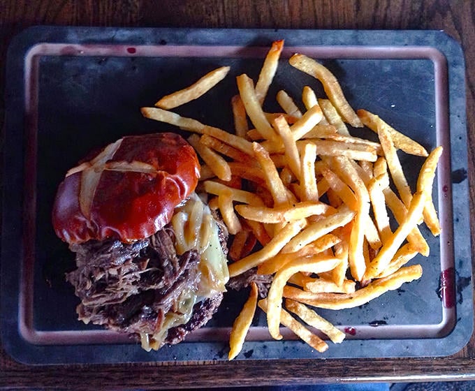 The fries arrive hot and crispy, seasoned with mysterious spices that make stopping at just one handful physically impossible.