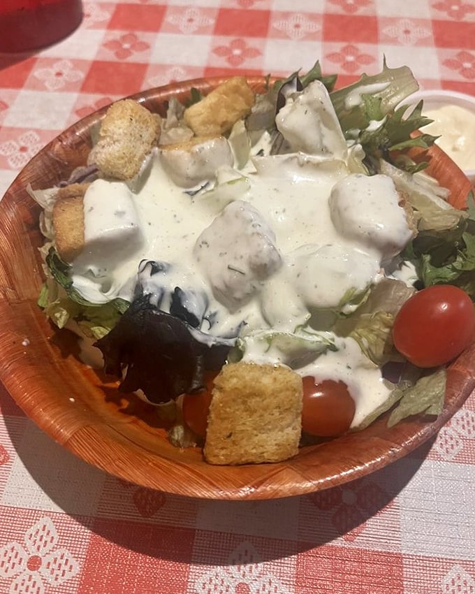 Even the salads deserve respect here &ndash; fresh greens, creamy dressing, and wooden bowls that would make a frontier homesteader proud.