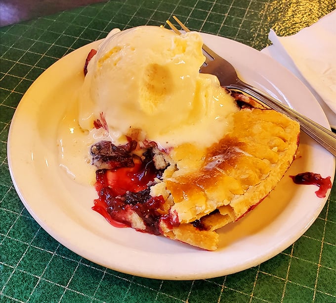 A symphony of crimson filling and melting ice cream creates a beautiful mess that demands to be savored slowly, one blissful bite at a time.