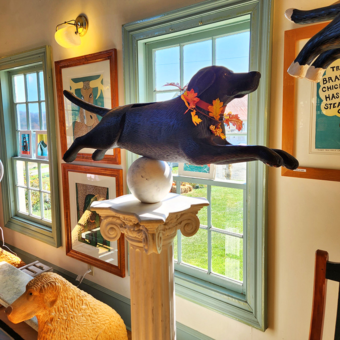 This playful sculpture of a black dog balanced impossibly on a pedestal captures the spirit of Dog Mountain &ndash; a place where canine joy defies gravity.