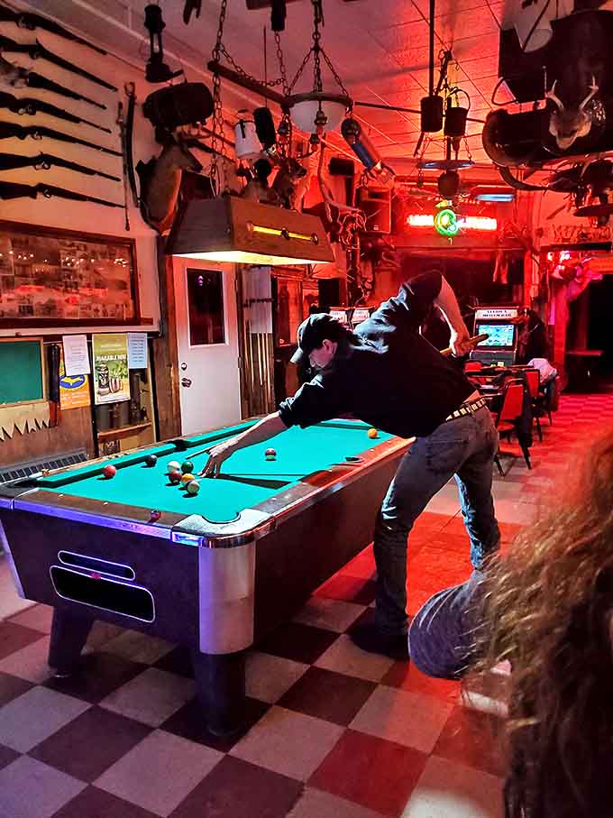 Between stories and sips, patrons can challenge each other to a game of pool, though concentrating might prove difficult with so many distractions.