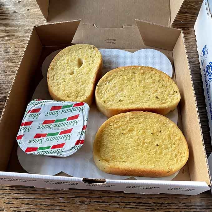 Golden, buttery garlic bread arrives ready for dipping in marinara sauce, the perfect way to start your meal or complement your pizza.