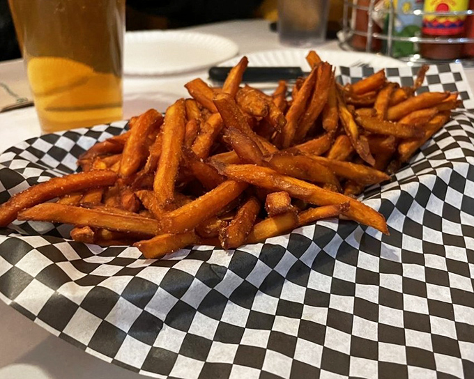 Sweet potato fries that achieve the impossible: crispy exterior, fluffy interior, and seasoned just enough to complement rather than compete.