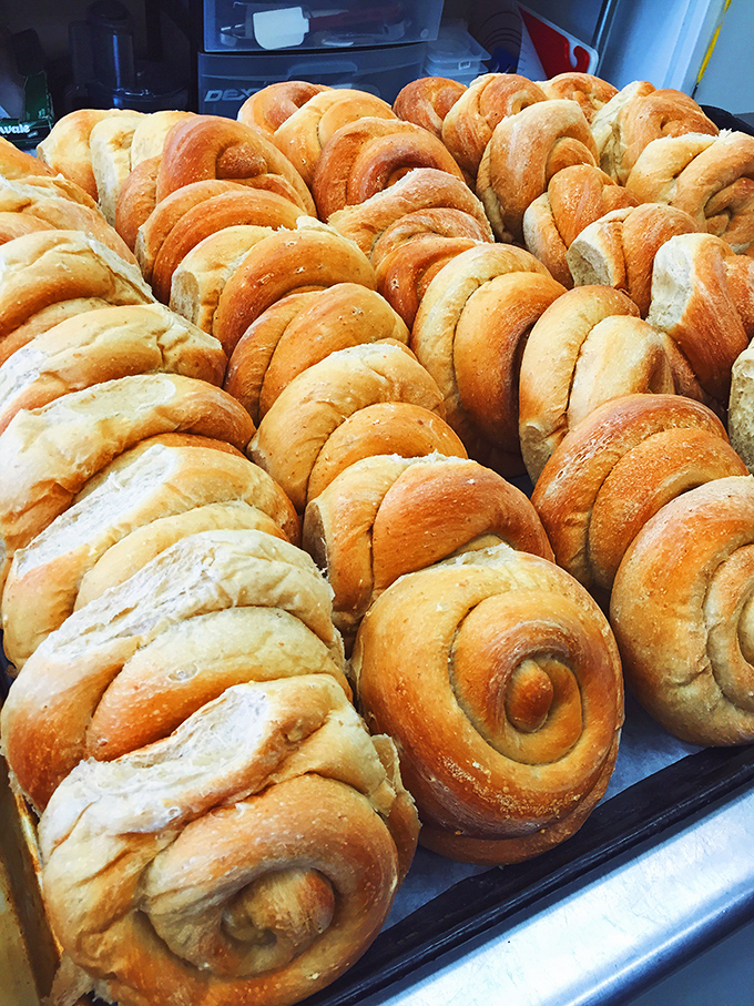 Freshly baked rolls cooling and ready for sandwich duty &ndash; these pillowy spirals are the foundation of Hero's Welcome's culinary reputation.