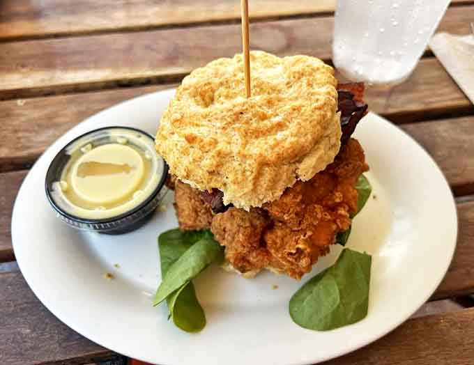 The Chicken Club: where a perfectly fried chicken breast meets its destiny between golden biscuit halves, with fresh greens playing matchmaker.