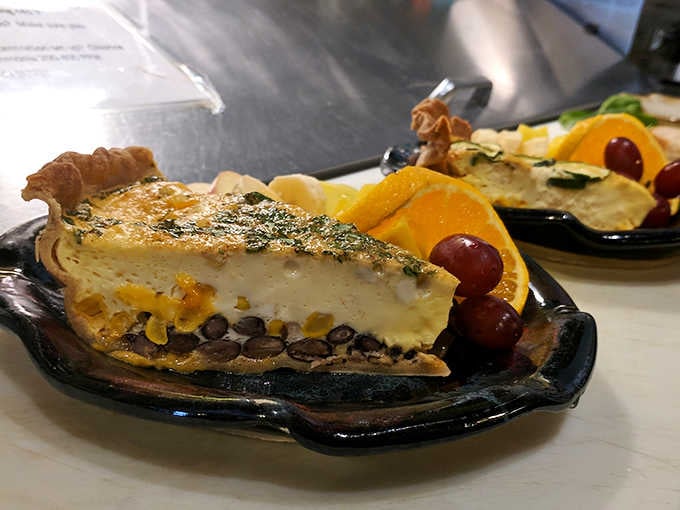 Behold the quiche that launched a thousand food pilgrimages&mdash;golden custard perfection nestled in a crust that whispers, "Butter is my love language."