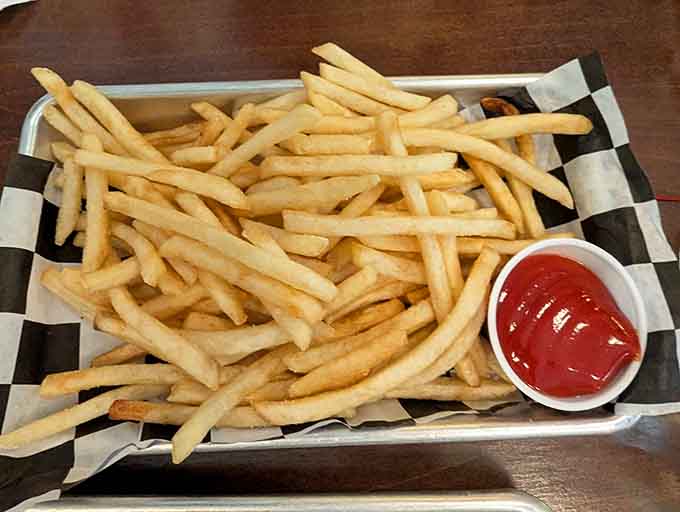 Perfectly golden fries stand at attention like delicious soldiers, crispy outside and fluffy inside, begging to be dipped in everything.