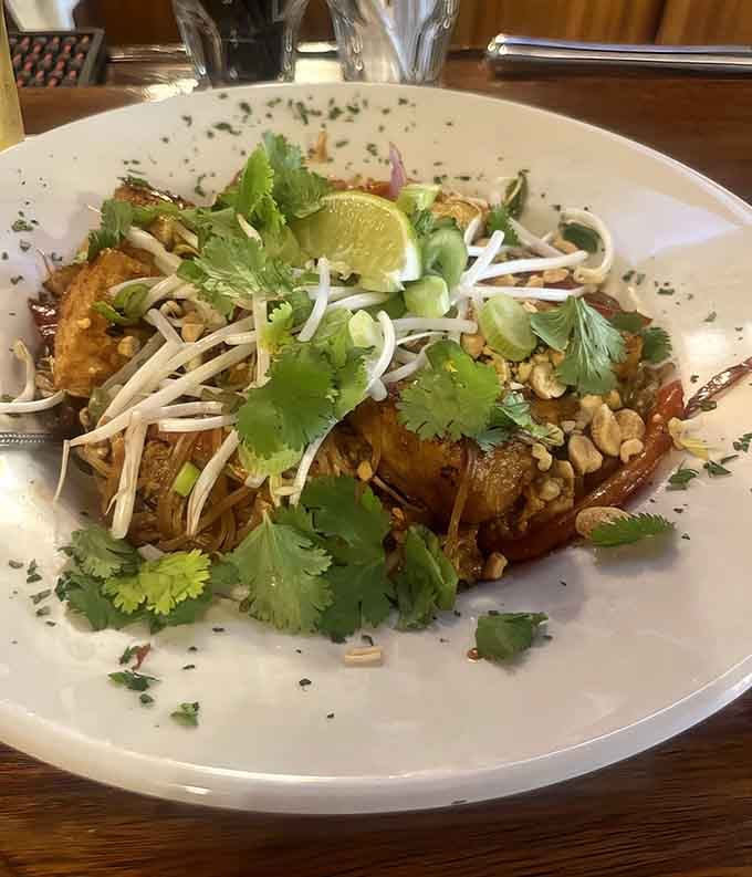 Pad Thai comes properly garnished with crushed peanuts and fresh cilantro, looking almost too photogenic to eat but tasting too good not to.
