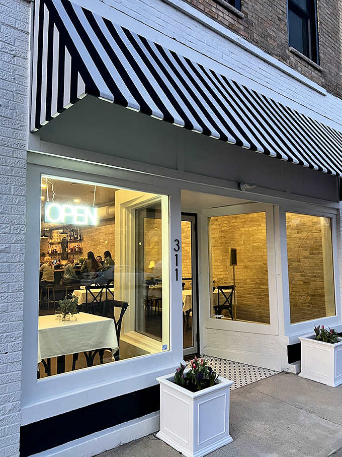 Three Eleven's inviting storefront promises culinary delights within, where black and white awnings signal classic small-town charm.