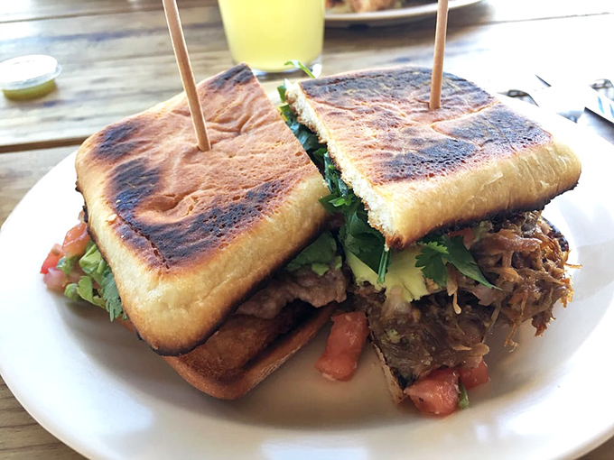 The Torta Al Pastor sandwich &ndash; where smoky, marinated pork meets toasted bread for a handheld flavor explosion that requires both hands.