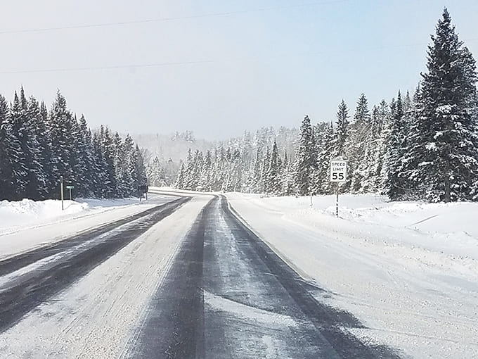 Winter transforms Highway 41 into a snow-globe scene, where the journey to Van Riper becomes part of the adventure.