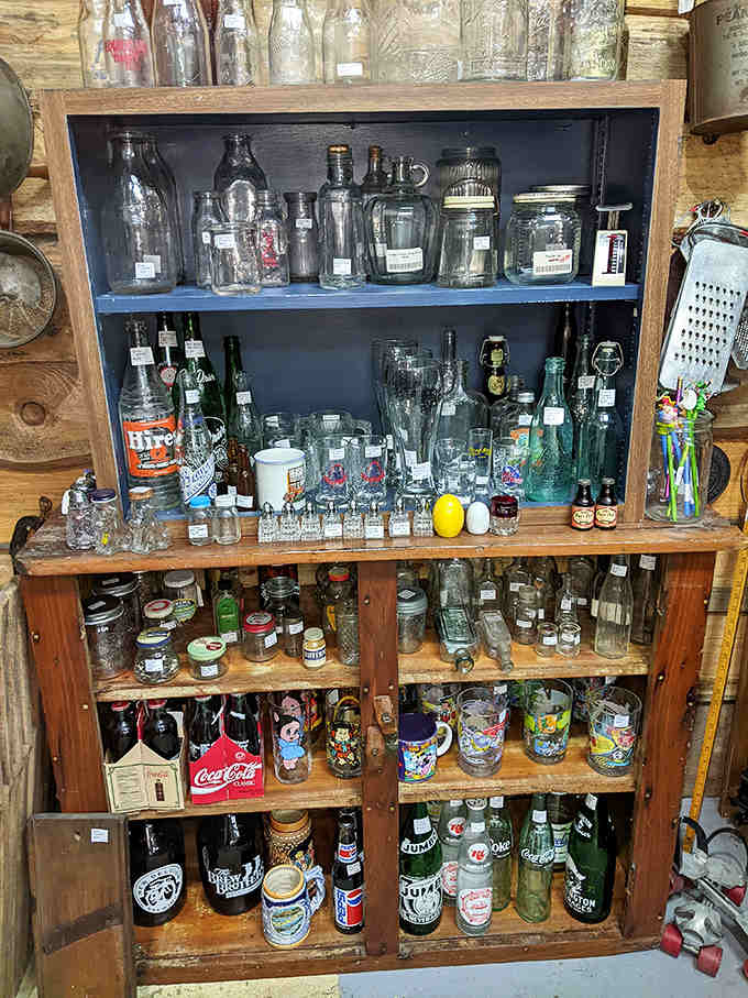 Vintage bottles line the shelves like liquid history &ndash; from old Coca-Cola classics to mysterious medicine containers, each glass vessel holding stories of bygone eras.