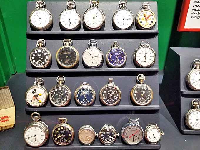 A collection of vintage pocket watches that once nestled against waistcoats and heartbeats, including a whimsical Mickey Mouse timepiece that brings unexpected charm.