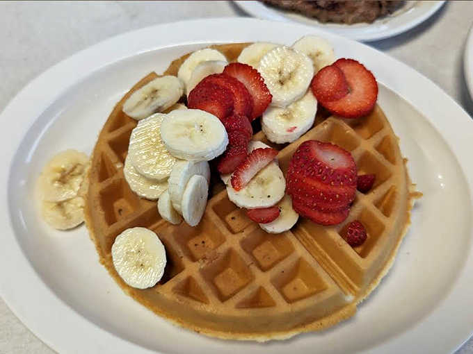 A golden throne for fresh fruit royalty, this crisp-edged waffle crowned with strawberries and bananas makes breakfast feel like dessert.