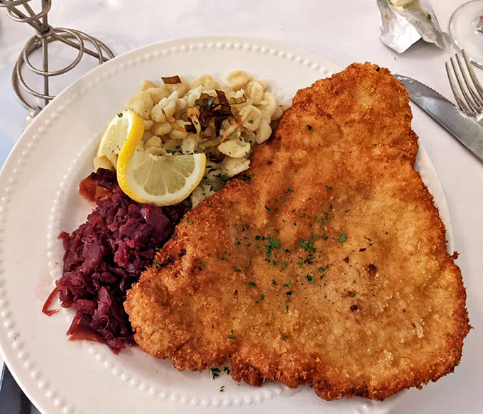 The Wiener Schnitzel arrives golden and enormous, accompanied by traditional German sides that transport you straight to Bavaria.