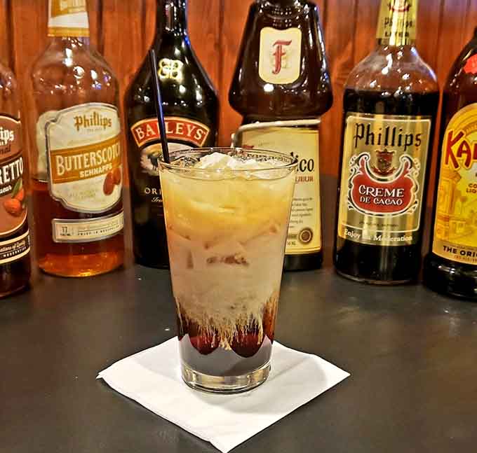 That layered drink situation looks like dessert met coffee and they decided to throw a party, complete with whipped cream and zero regrets.