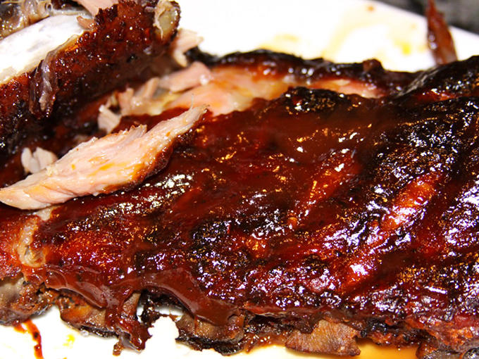 That glistening exterior isn't just for show &ndash; it's a flavor-packed crust protecting meat that's been transformed by hours of gentle smoke.