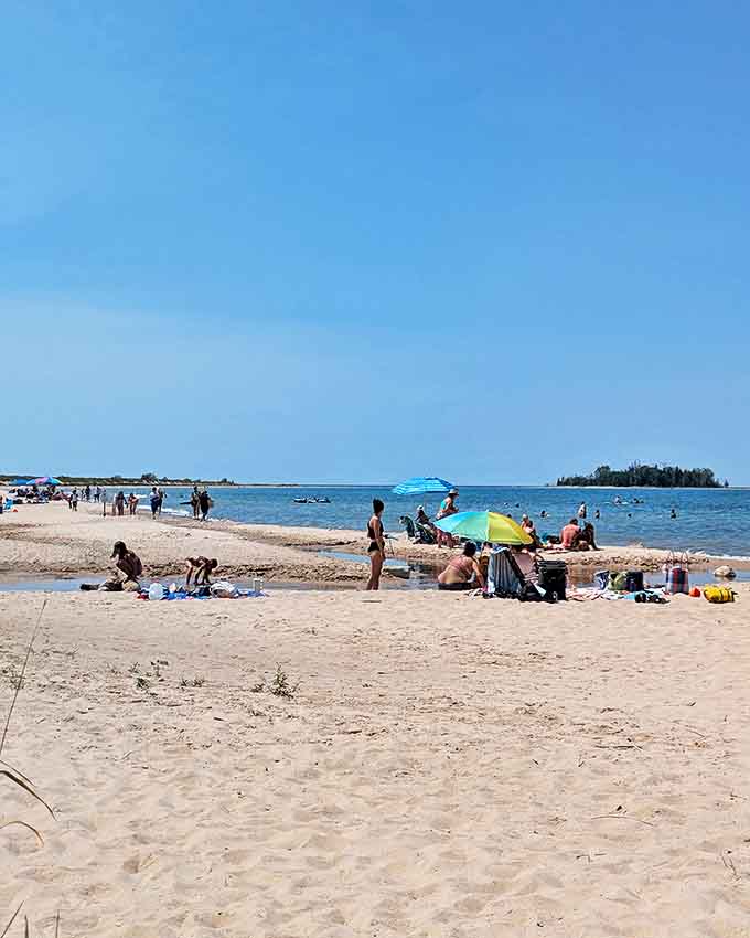 Beach day perfection: Where families create memories on shores that somehow remain uncrowded even during peak summer, a Michigan miracle.
