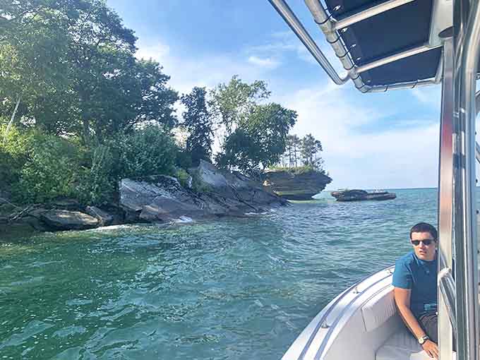 Exploring by boat offers a different perspective of the shoreline's dramatic limestone cliffs and hidden coves near Port Austin.
