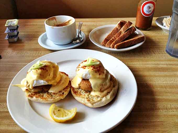 Morning sunshine on a plate: golden English muffins supporting delicate crab cakes and poached eggs, all bathed in hollandaise that gleams like liquid gold.