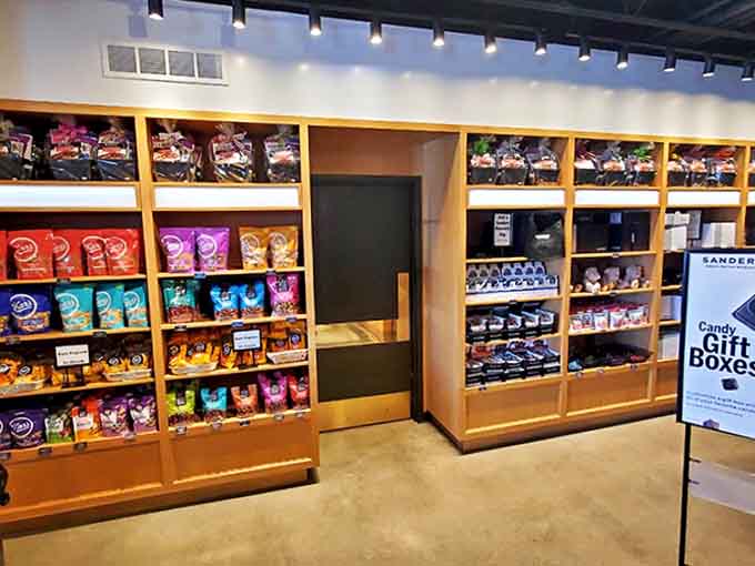 The chocolate display wall showcases an impressive arsenal of sweet weapons, organized with the precision of a sugar-fueled military operation.