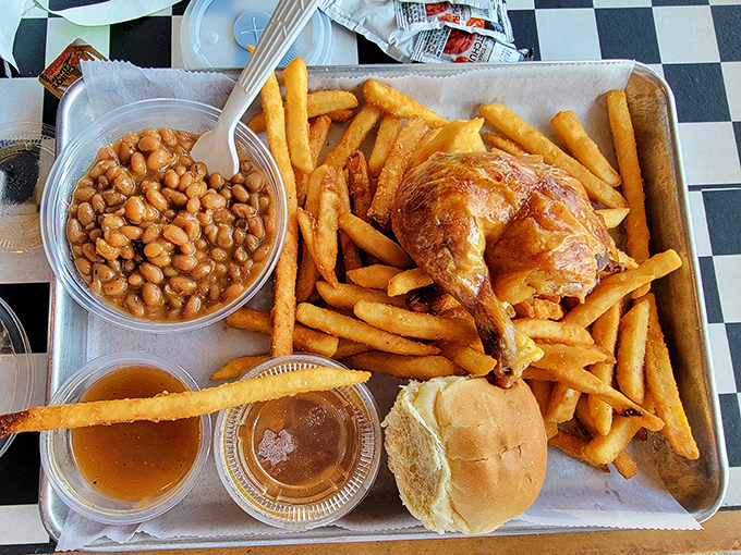 A hearty plate featuring perfectly cooked chicken alongside baked beans that have clearly been simmering with purpose and dedication.